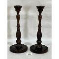 A pair of early 20th century carved lignum vitae candlesticks. 12in ...
