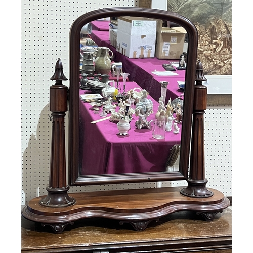 A Victorian mahogany dressing glass with arched plate, fluted uprights ...