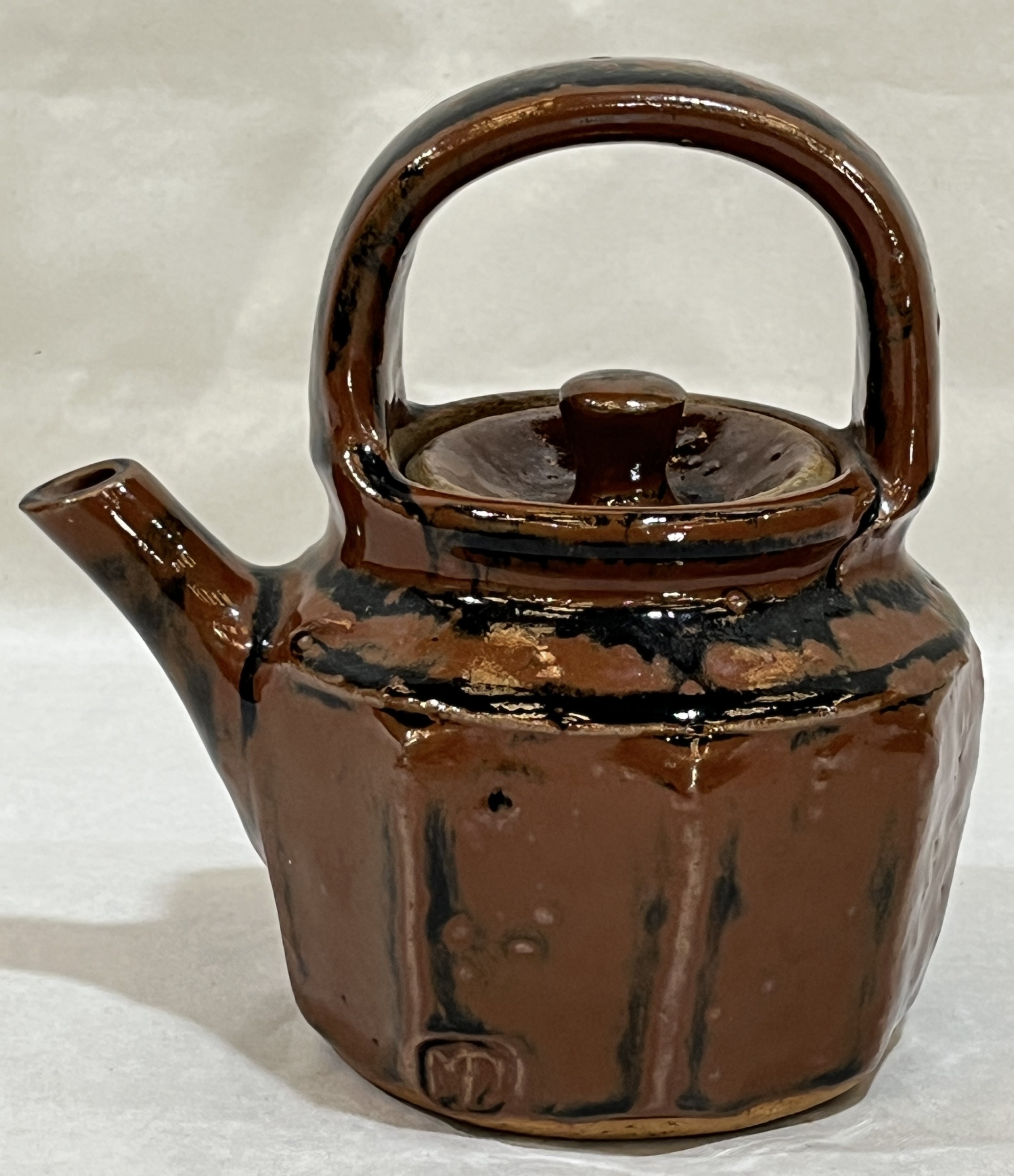 Mike Dodd (born 1943) small stoneware faceted teapot, tenmoku glaze ...