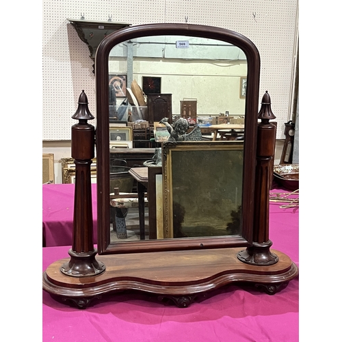 A Victorian mahogany dressing glass with arched plate, fluted uprights ...