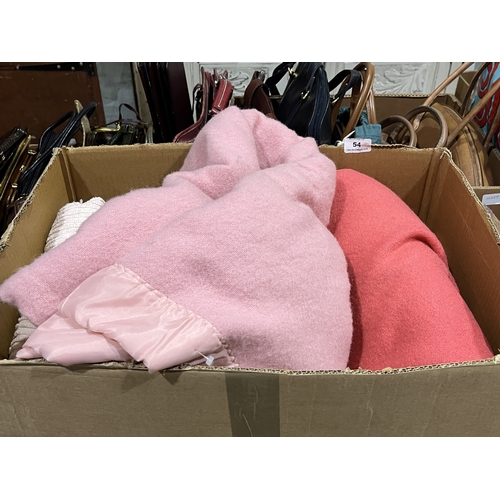 Two boxes of bed throws, linen table cloth and wool blankets