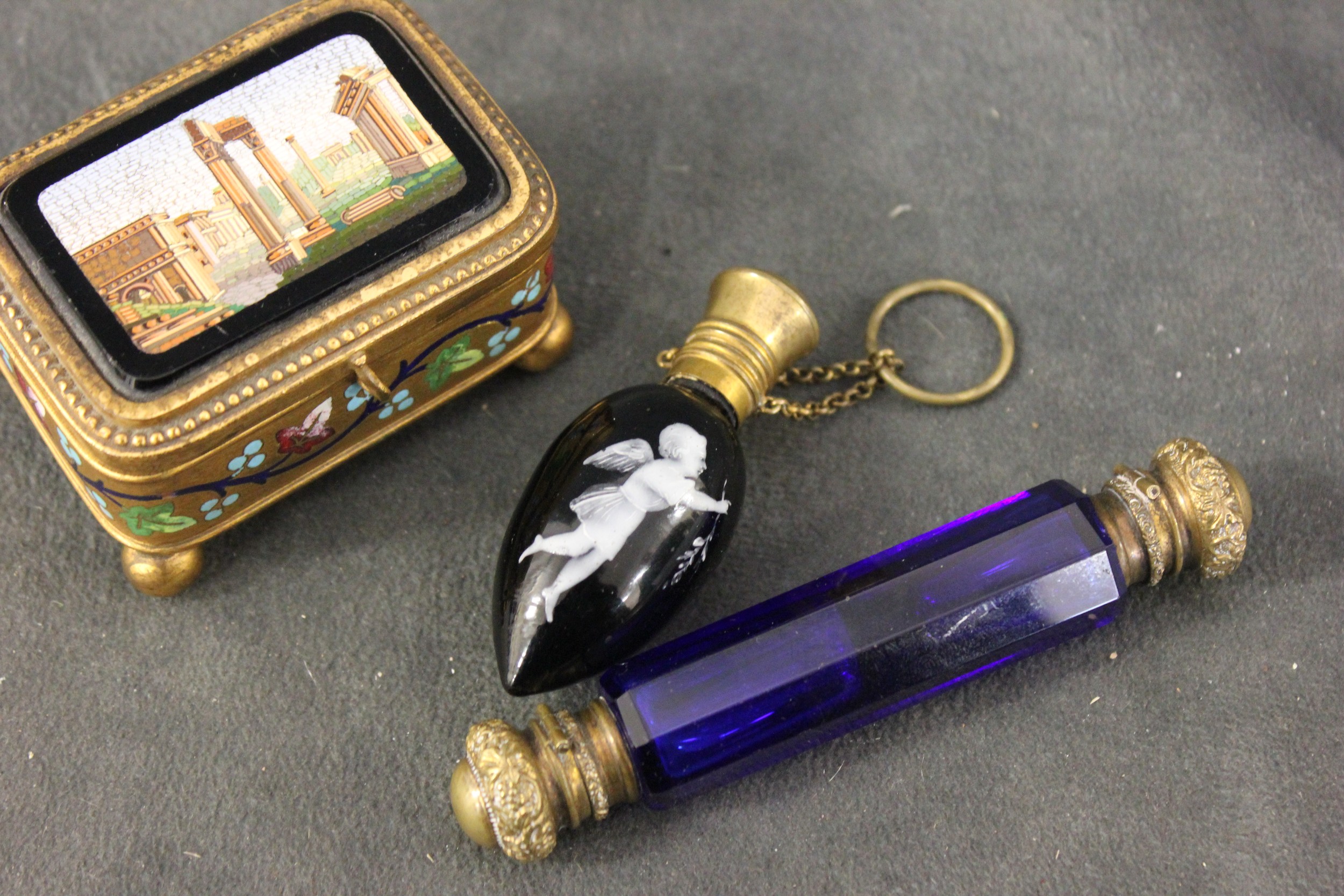 A small gilt metal micro mosaic and enamelled trinket box, showing ...