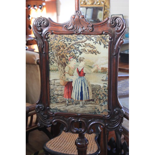 A Victorian mahogany polescreen, with needlework central panel, 170cm high.