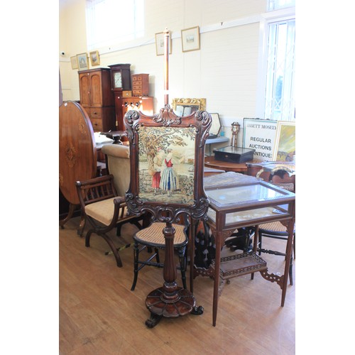 A Victorian mahogany polescreen, with needlework central panel, 170cm high.
