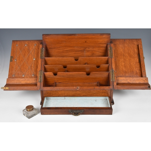 A late 19th / early 20th century oak desk tidy, with two fold out doors ...