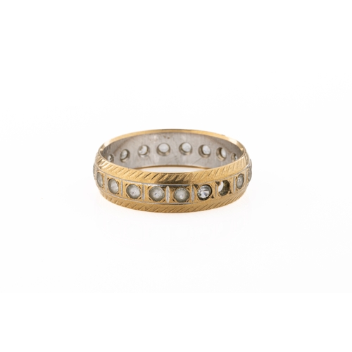A silver and paste ring The silver eternity ring set with round-cut ...
