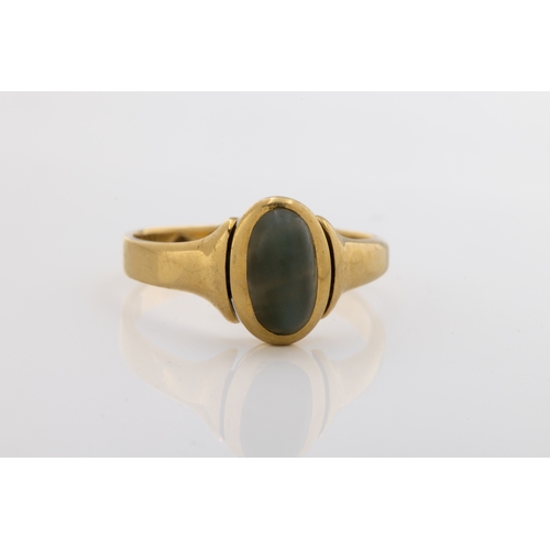 A 18ct yellow gold and hawk's eye ring. set with an oval cabochon stone ...
