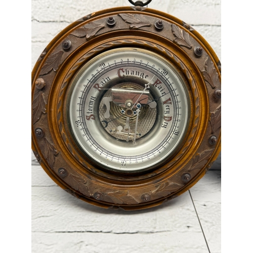 Two Round Wooden Barometers