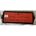 An early cast iron LMS Train Lighting fuse box door.