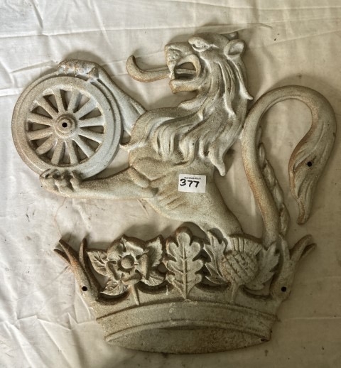 A cast iron railway related wheel makers logo depicting lion and wheel ...