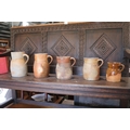 Five antique French pottery loop handle jugs, approx 27cm H and shorter (5)