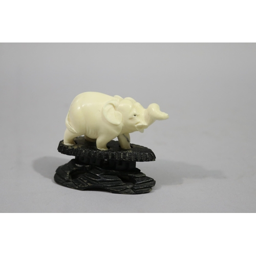 Small carved ivory elephant, wooden stand, small chip to the trunk end ...