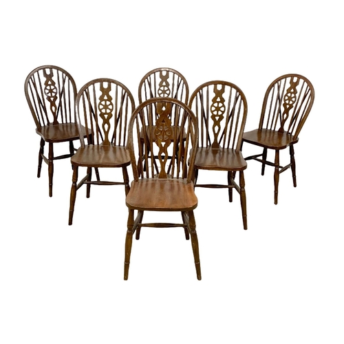 A set of 6 beech wheel back chairs.