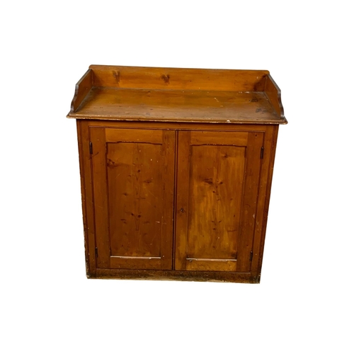 A Victorian pine gallery back side cabinet. 94 x 50 x 99cm.