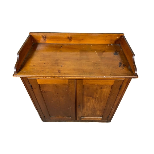 A Victorian pine gallery back side cabinet. 94 x 50 x 99cm.