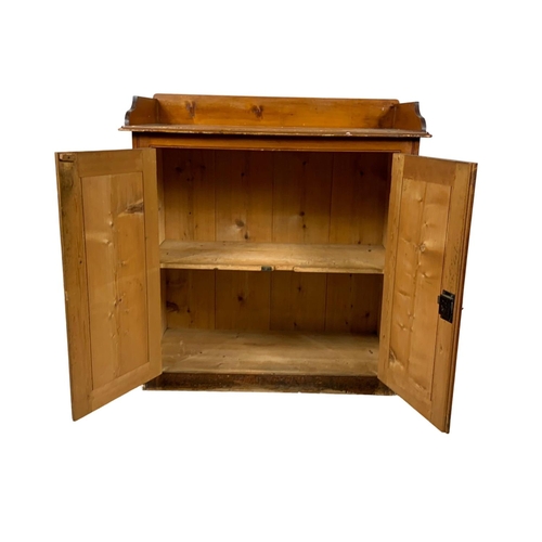 A Victorian pine gallery back side cabinet. 94 x 50 x 99cm.