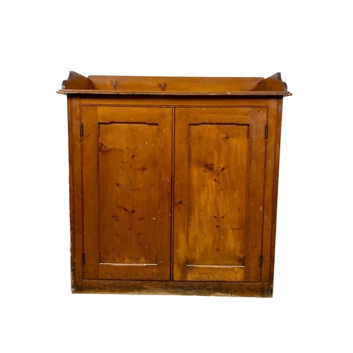 A Victorian pine gallery back side cabinet. 94 x 50 x 99cm.