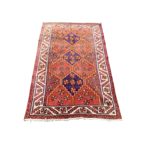 A vintage Middle Eastern hand knotted rug 135 x 205cm