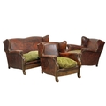 A 3 piece 1920’s leather wingback suite, with brass stud buttons and ...