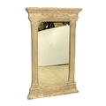 A large ornate heavy gilt framed mirror with Corinthian style pillars ...