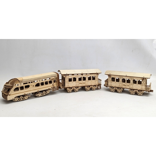 A quantity of Wood Trick models including train, geared safe, etc.