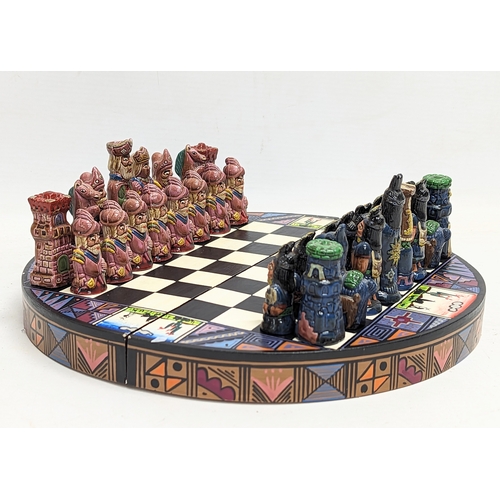 A painted medieval style chess set. Board measures 26cm
