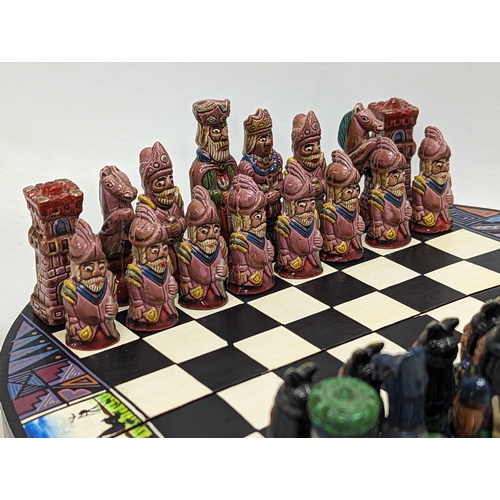 A painted medieval style chess set. Board measures 26cm