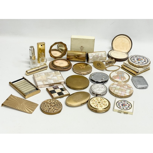 A collection of vintage compacts and perfume bottles
