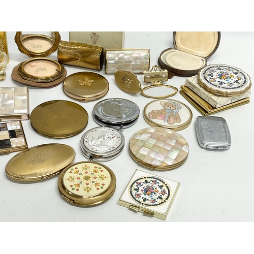 A collection of vintage compacts and perfume bottles