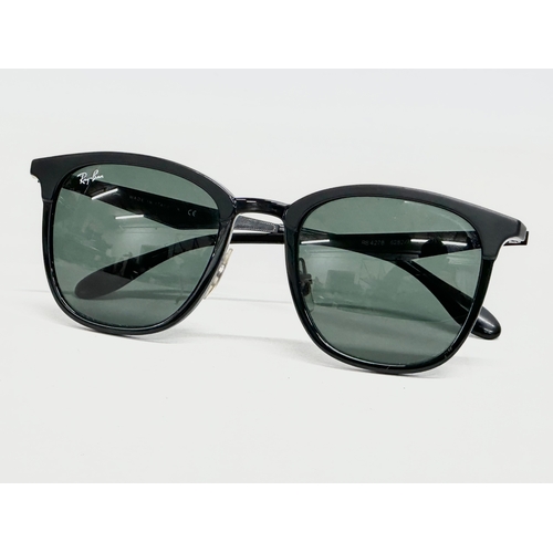 A pair of Ray Ban ‘Luxottica’ sunglasses with case.