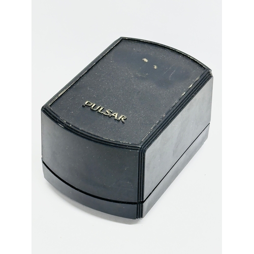A Pulsar watch with case.