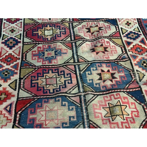 A large vintage Middle Eastern hand knotted runner rug. 255x106cm