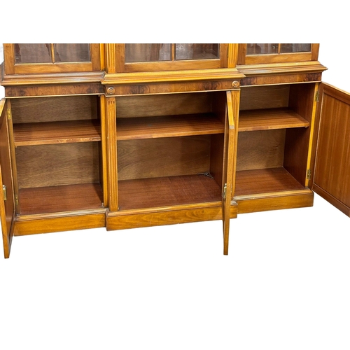 A large good quality George III style Yew Wood breakfront bookcase with ...
