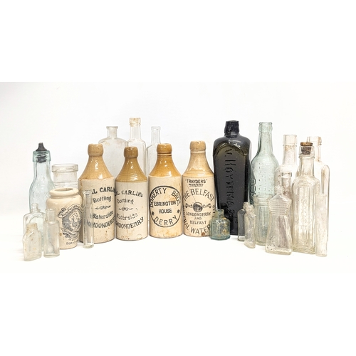 A collection of late 19th / early 20th century glass and stone bottles ...