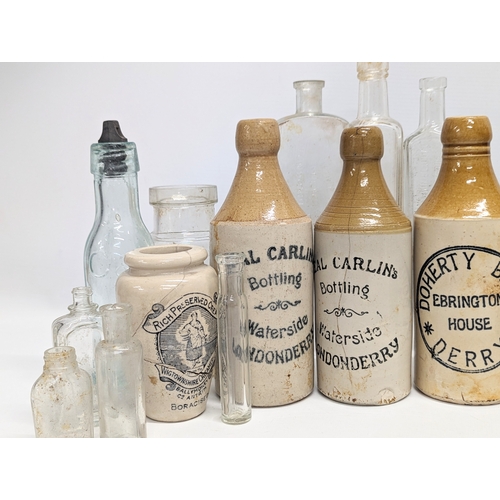 A collection of late 19th / early 20th century glass and stone bottles ...