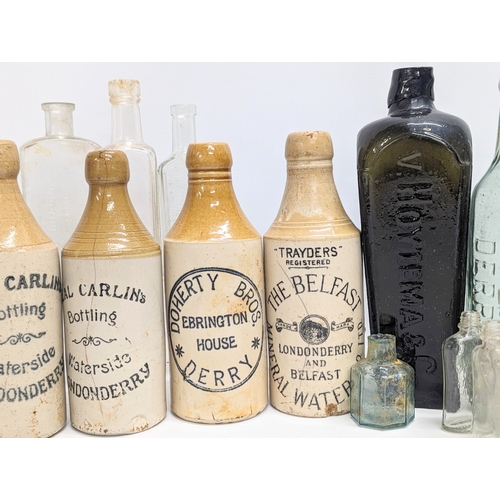 A collection of late 19th / early 20th century glass and stone bottles ...