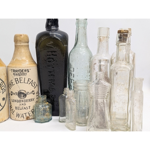 A collection of late 19th / early 20th century glass and stone bottles ...