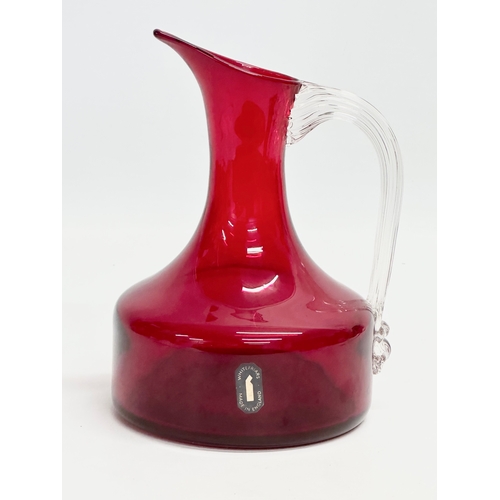 A Ruby Glass jug designed by Geoffrey Baxter for Whitefriars. 12x17cm