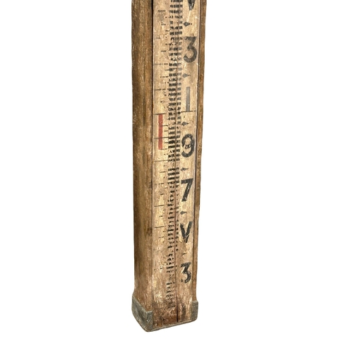 A large vintage surveyors telescopic measuring stick. Closed 190cm ...