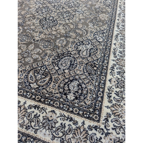 A vintage Middle Eastern style rug. 140x212cm