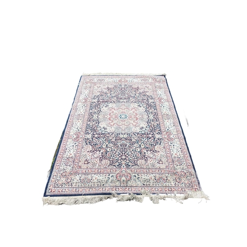 A large good quality Middle Eastern hand knotted rug. 168x256cm