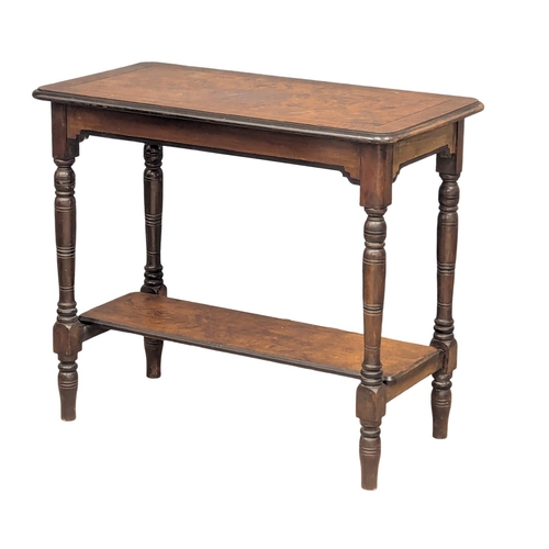 A Late Victorian inlaid walnut two tiered side table on reeded legs ...