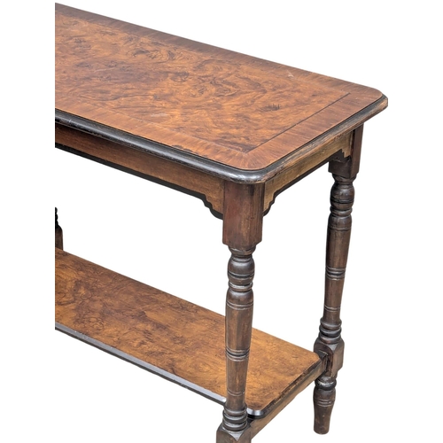 A Late Victorian inlaid walnut two tiered side table on reeded legs ...