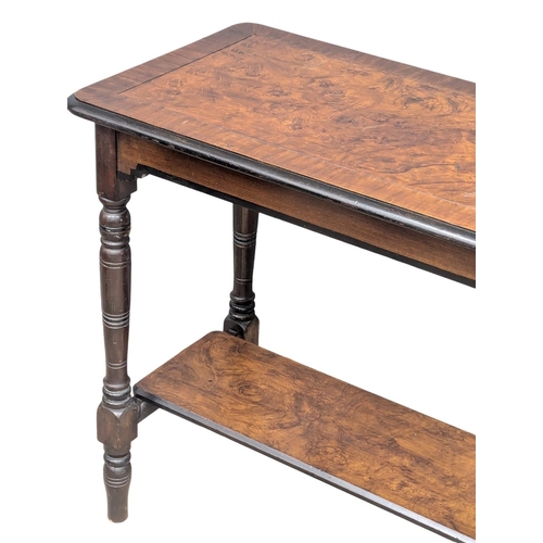 A Late Victorian inlaid walnut two tiered side table on reeded legs ...
