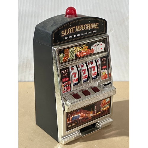 A Bandit slot machine money bank. 20x15x37cm