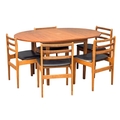 A Mid Century teak and beech extending dining table and 5 dining chairs.(3)