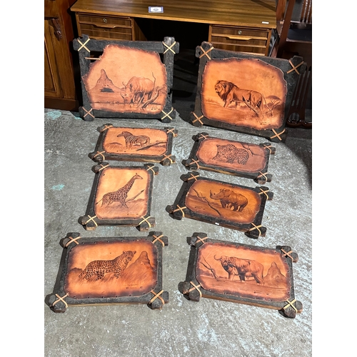 A set of African leather hide wall plaques with wooden frames. 70x60cm ...