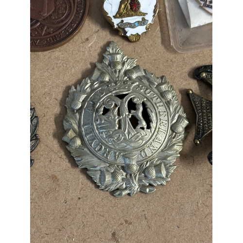 A collection of military badges, buttons and medallions. Including ...