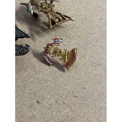 A collection of military badges, buttons and medallions. Including ...