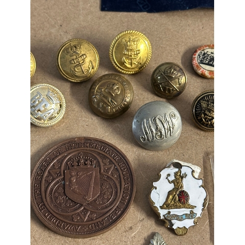 A collection of military badges, buttons and medallions. Including ...